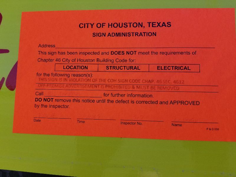 whats up with the bright orange stickers on signs